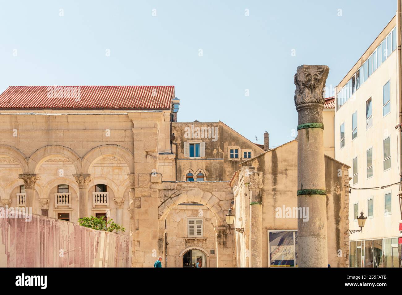 Ancient Roman column stands prominently in front of historical Church ...