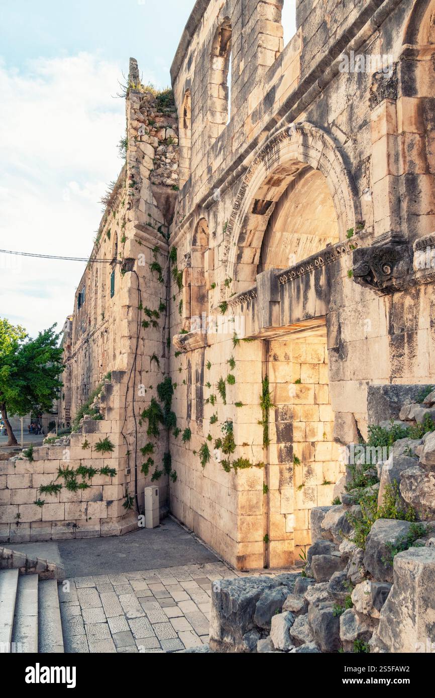 Sunlight illuminates the ancient stone walls and siilver gate and ...