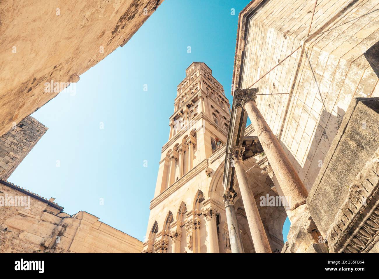 Bell tower of an ancient stone St Domnius cathedral rising into the ...