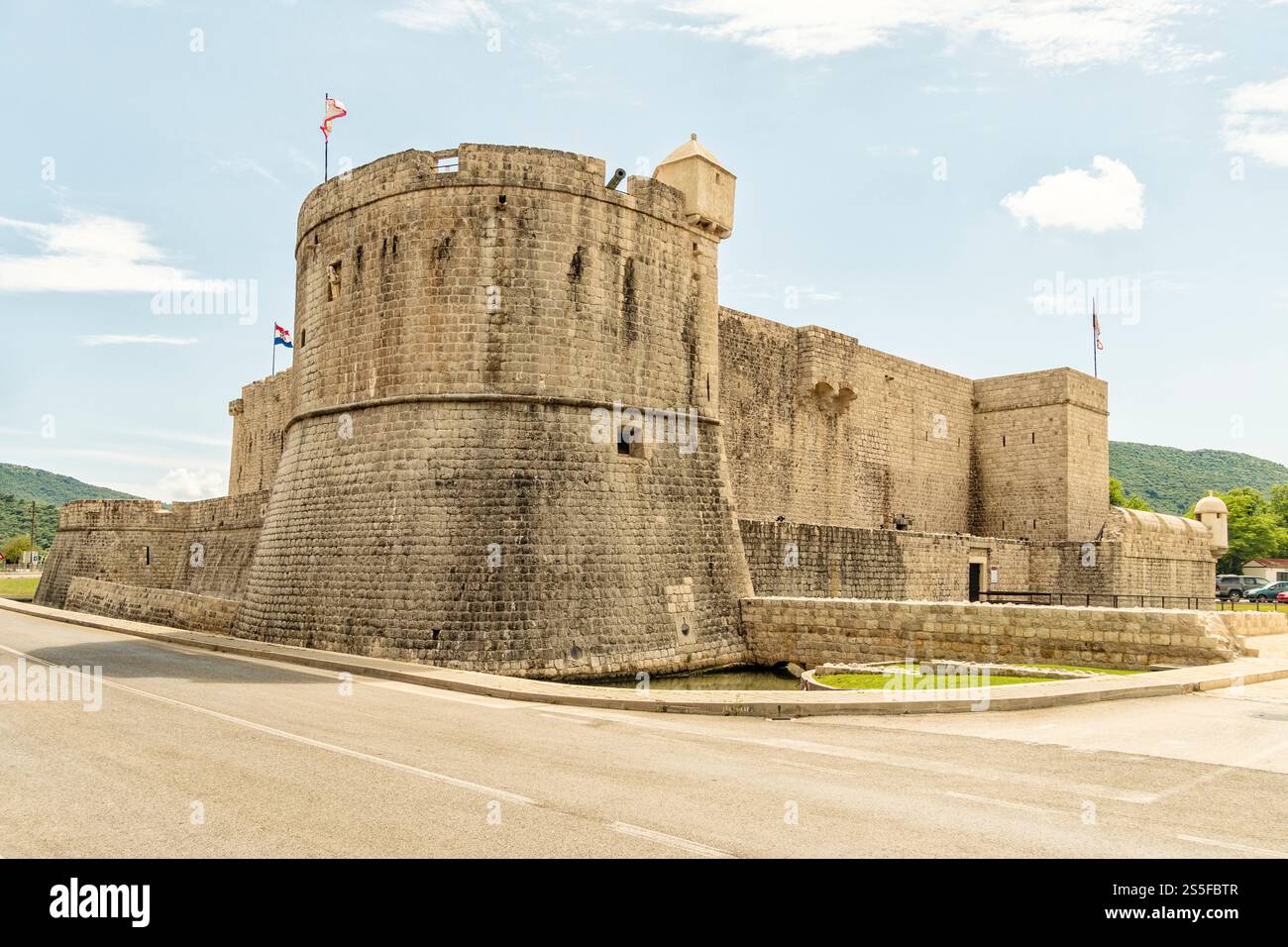 Medieval Kastio Fort stands proudly under a blue sky with wispy clouds ...