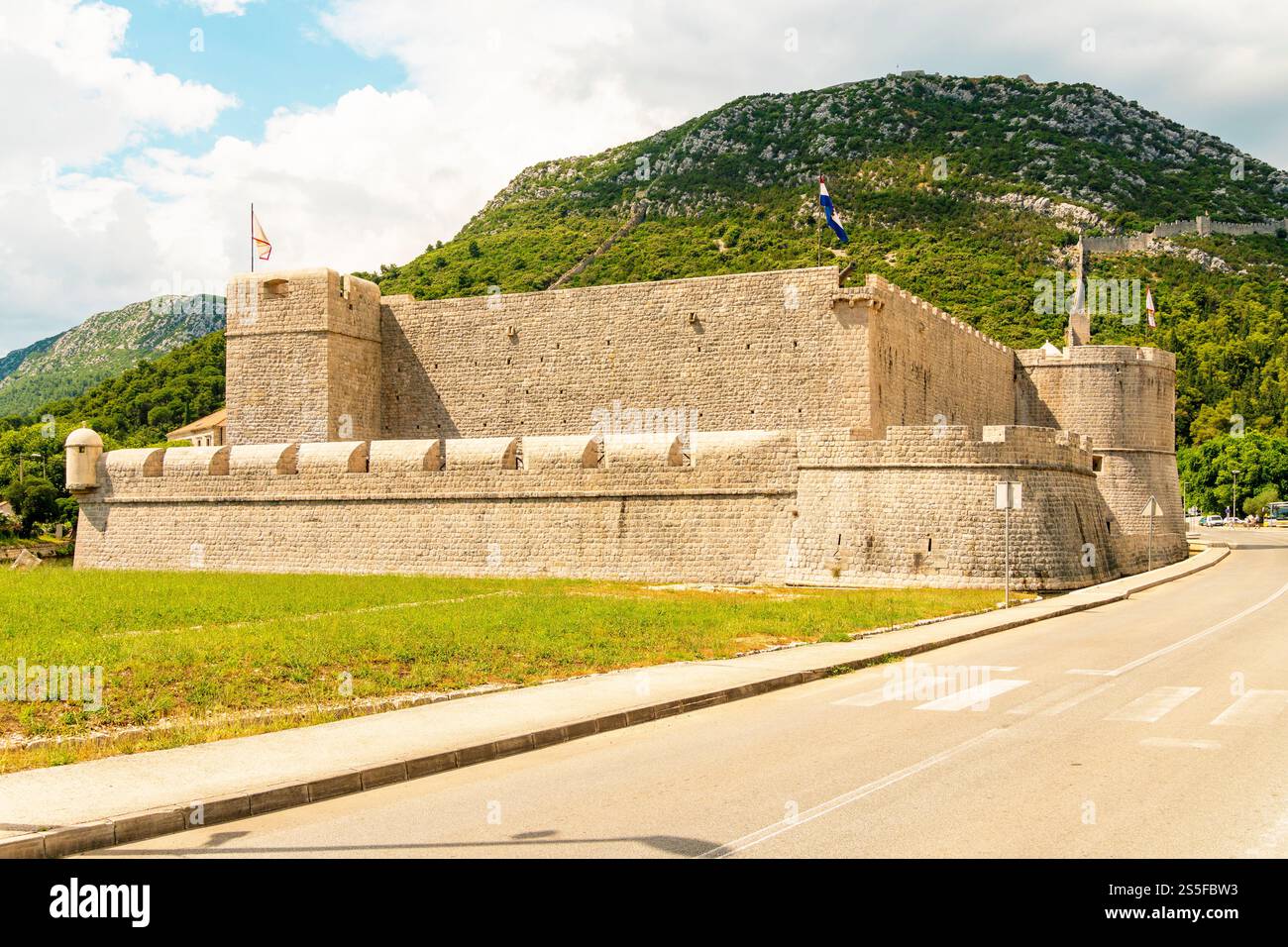 Stone fort kastio battlements flags cloudy sky hi-res stock photography ...
