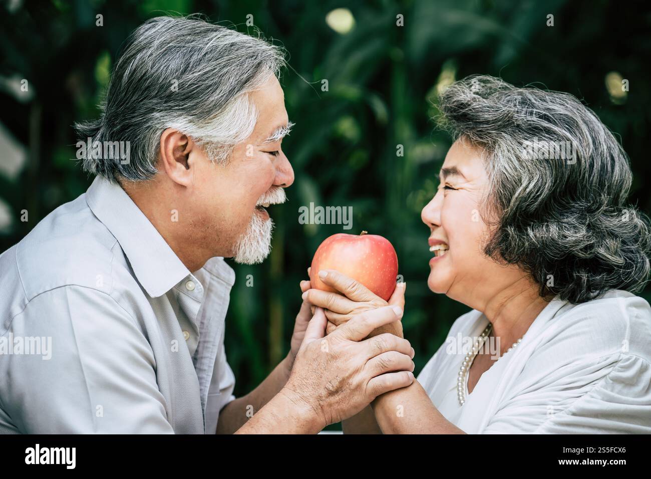 Elderly Couples Playing and eating some fruit Stock Photo - Alamy