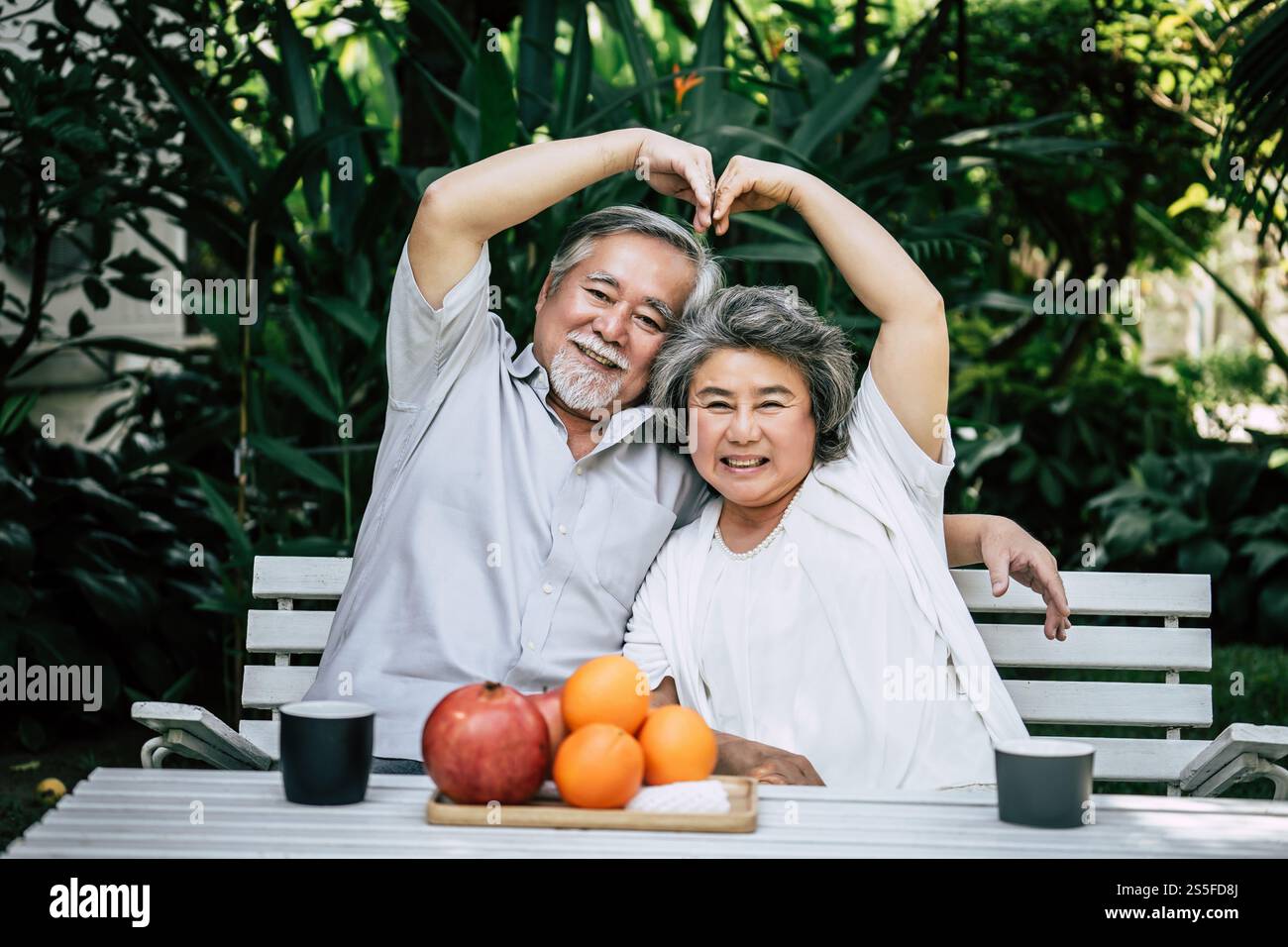 Elderly Couples Playing and eating some fruit Stock Photo - Alamy