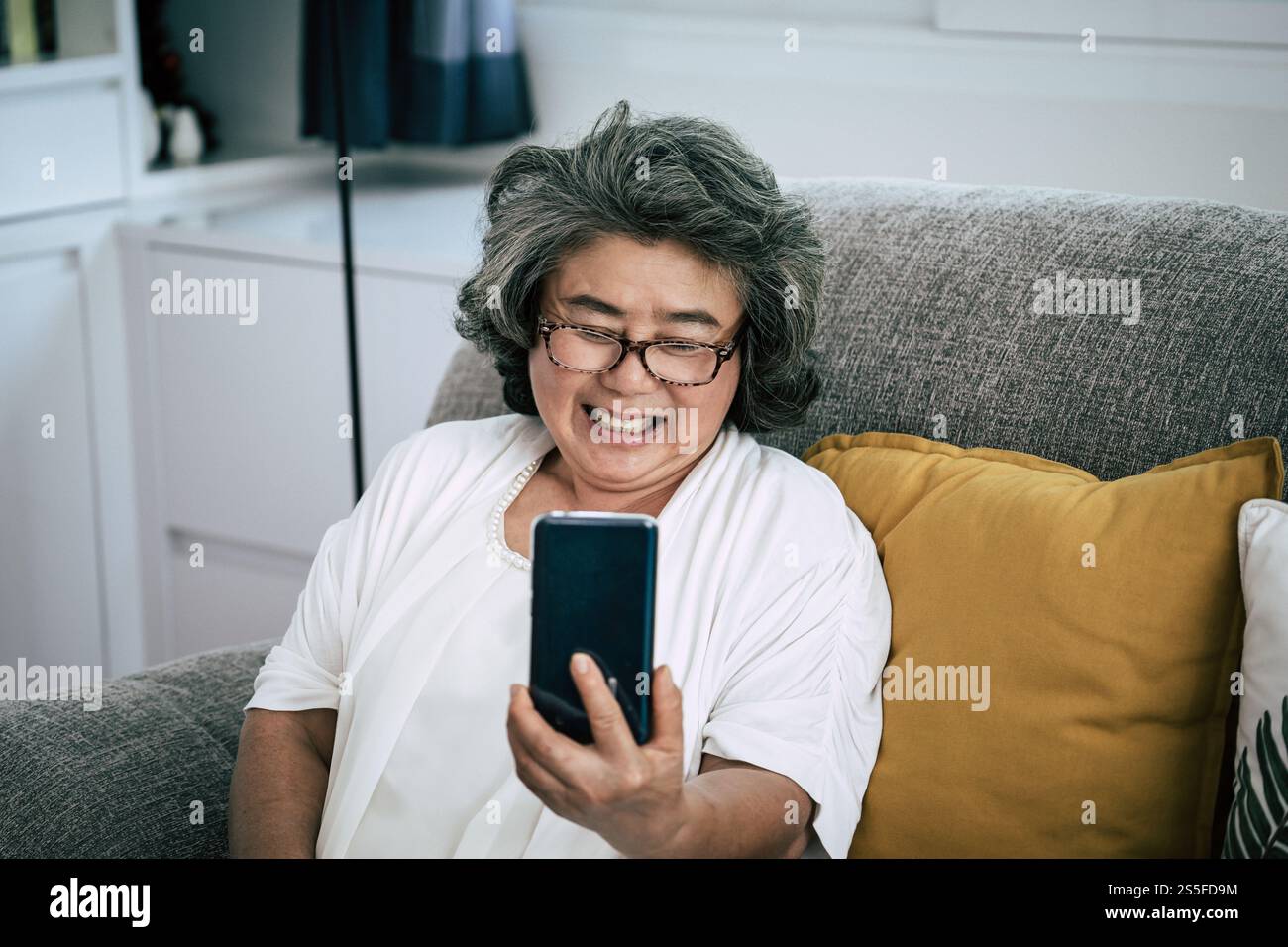 Senior woman Video call with family Stock Photo - Alamy
