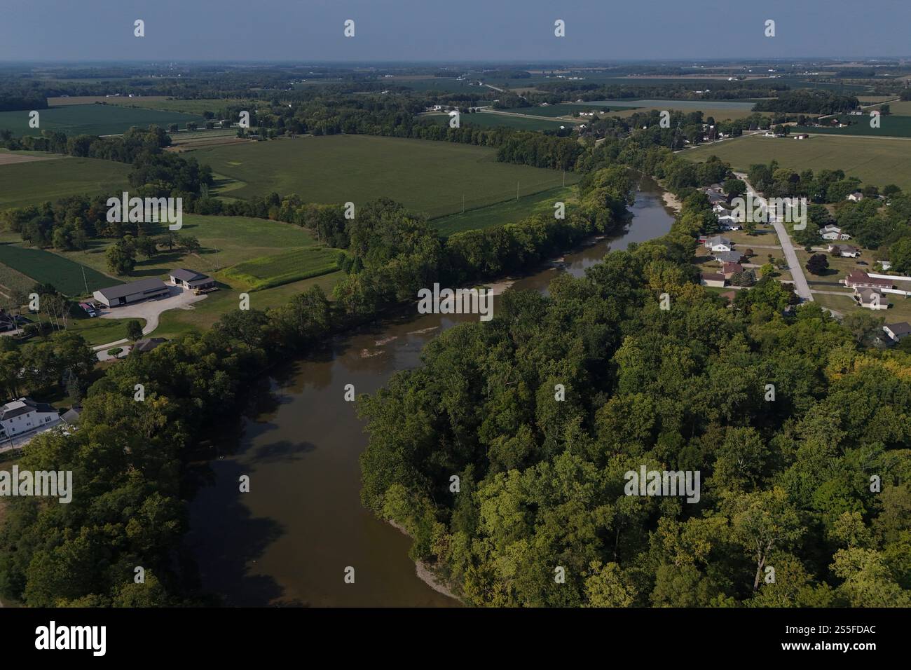 FILE - Water flows down the Sandusky River between farms, Aug. 26, 2024 ...