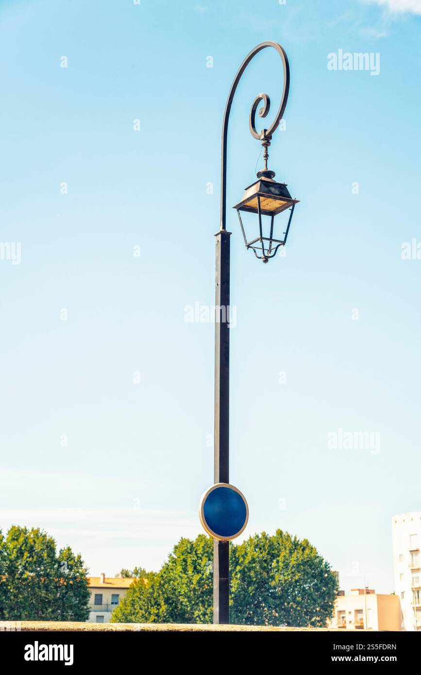 Classic Light Pillar or lamp post with blue sky and traffic sign arrow ...