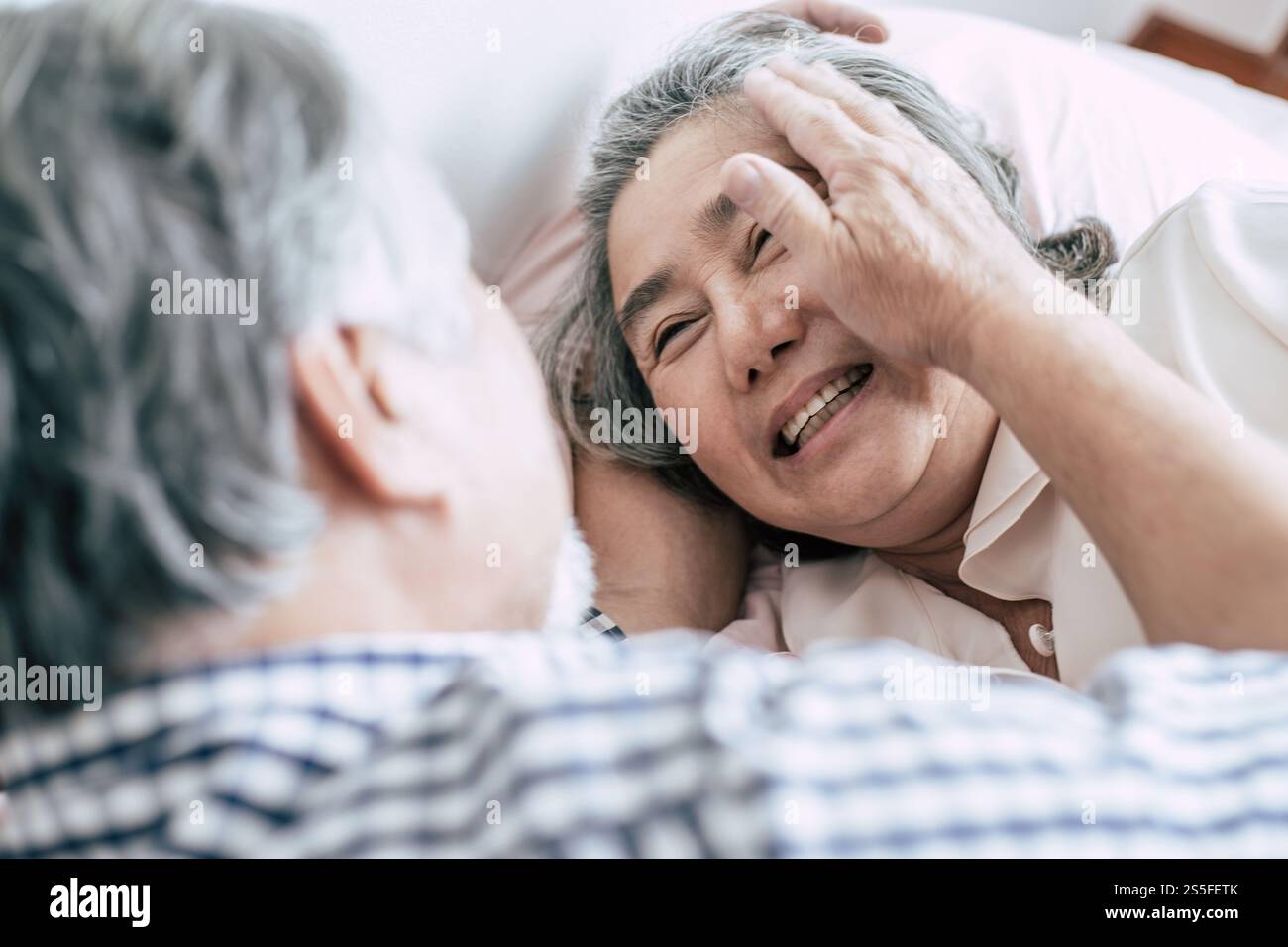 Elderly woman lying in bed hi-res stock photography and images - Alamy