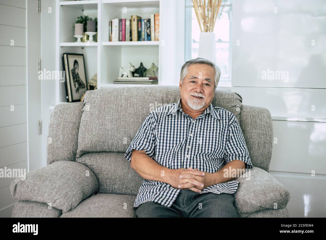 Happy senior man sitting sofa hi-res stock photography and images - Alamy