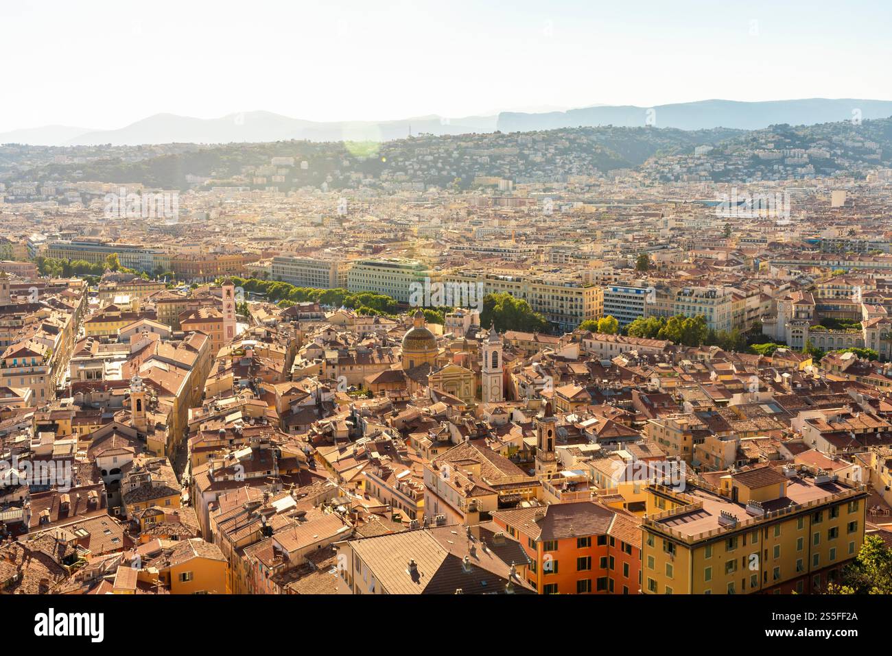 Aerial view of a sprawling cityscape basking in the golden light of the ...