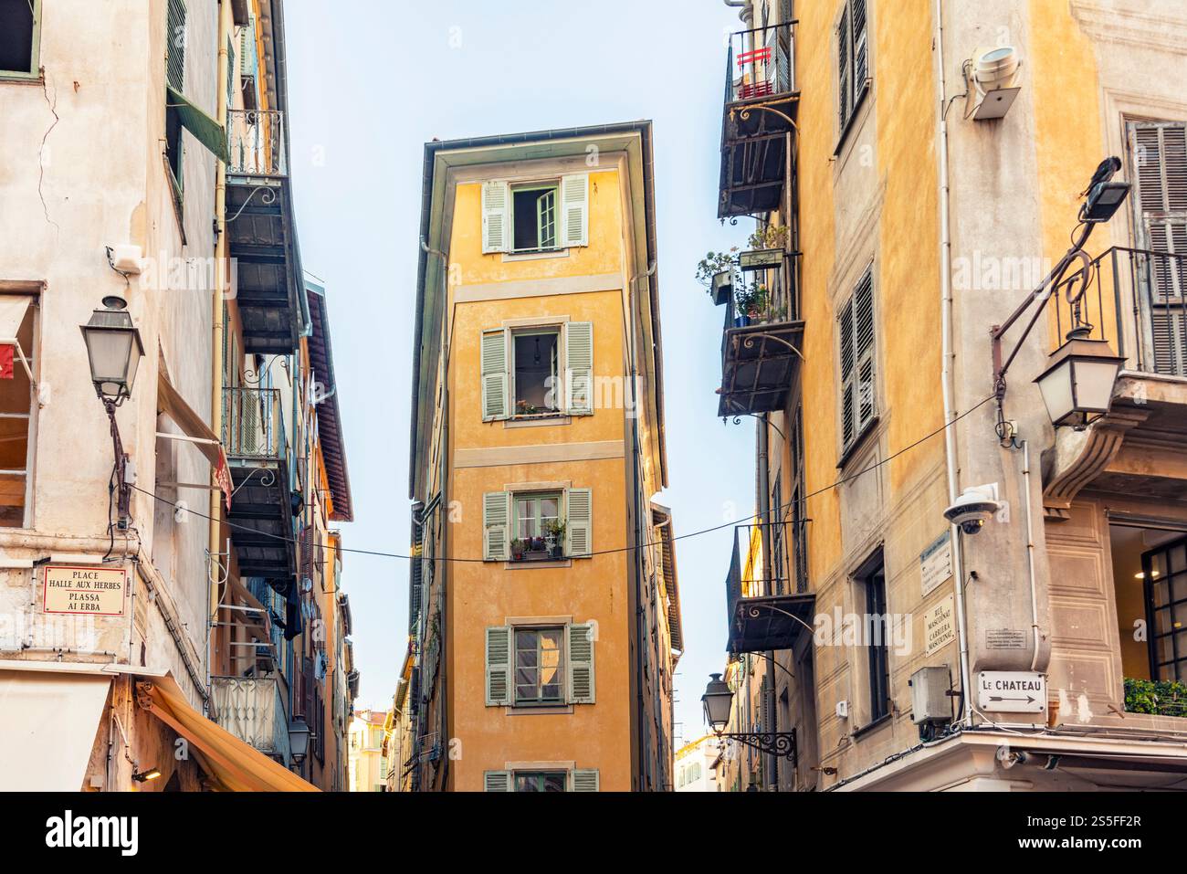 Narrow street with tall, colorful buildings and small balconies in an ...
