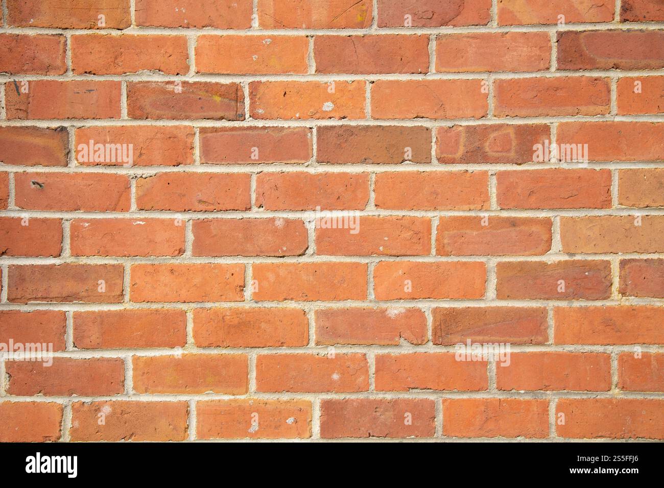 Orange brick wall with a classic staggered pattern and visible mortar ...