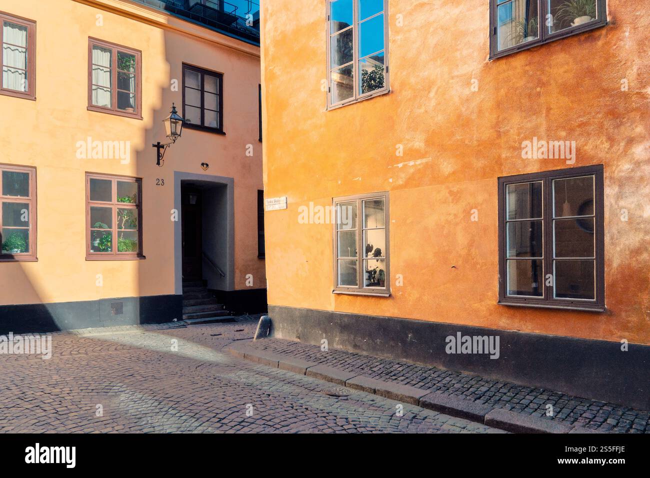 Sunlight casts shadows on the colorful facades of traditional buildings ...