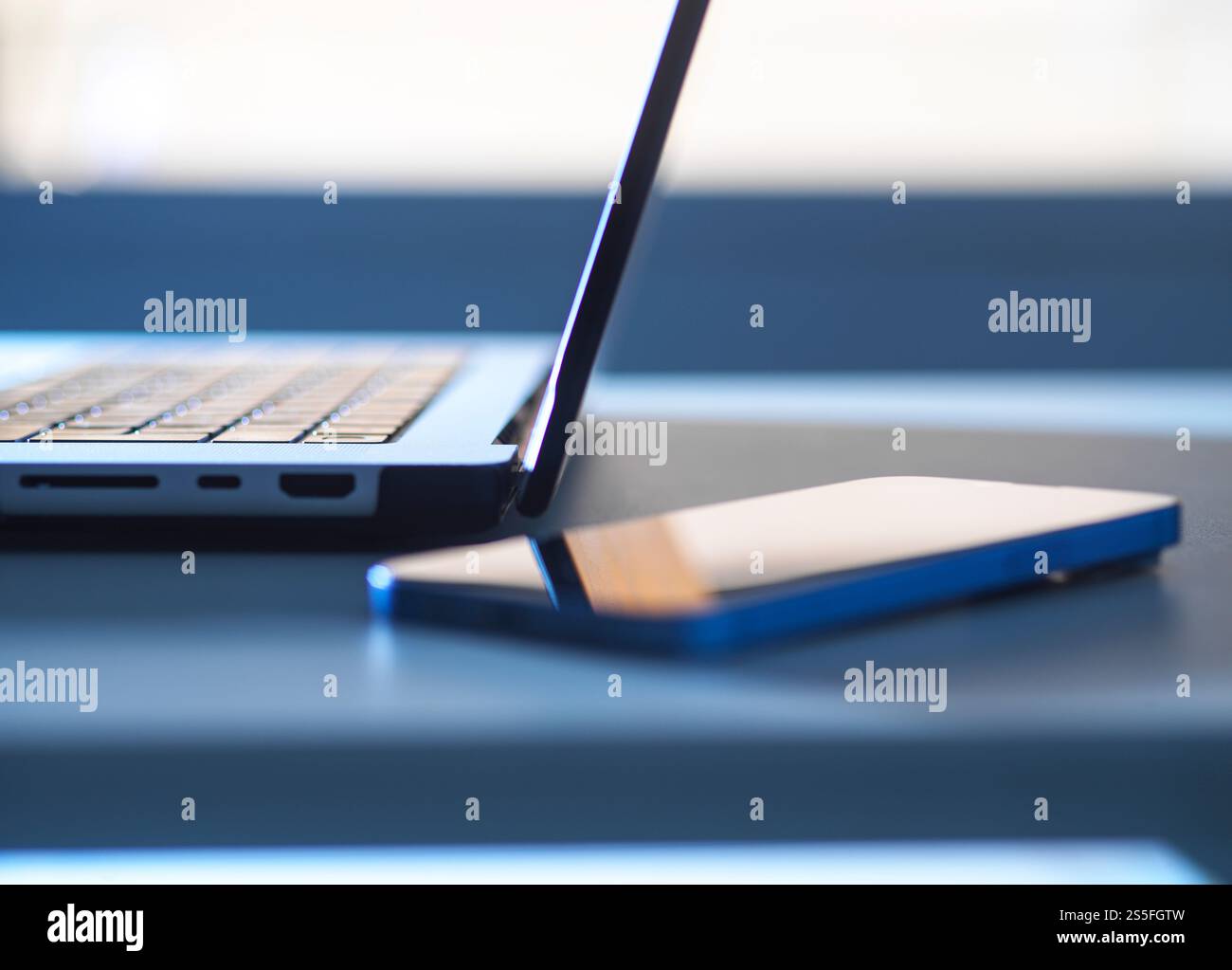 laptop computer with sunlight coming through window Stock Photo - Alamy