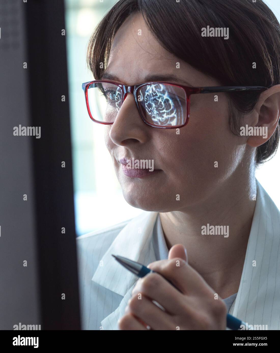 Doctor viewing a patients MRI Brain scan for ageing and damage due to ...