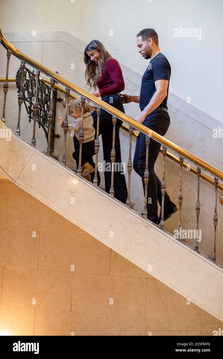 Family descending grand staircase ornate balusters hi-res stock photography and images - Alamy