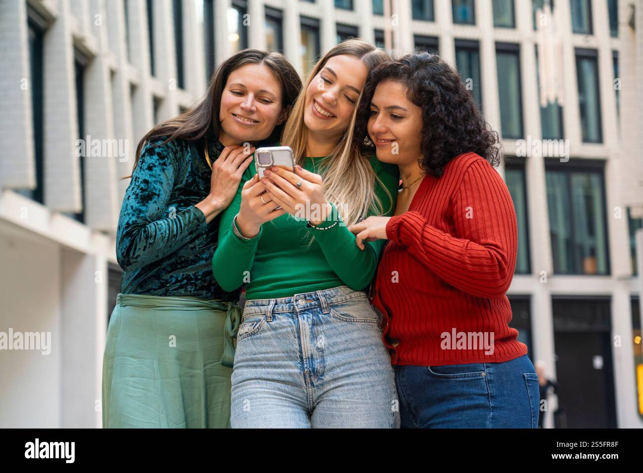 Group women huddled together smiling hi-res stock photography and ...