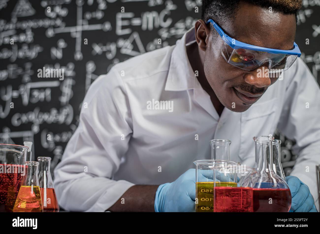 Scientists look at the chemicals in glass at the laboratory Stock Photo ...