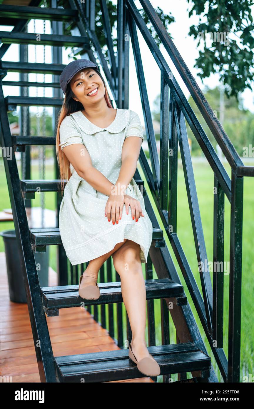 Woman sitting on modern outdoor hi-res stock photography and images - Alamy