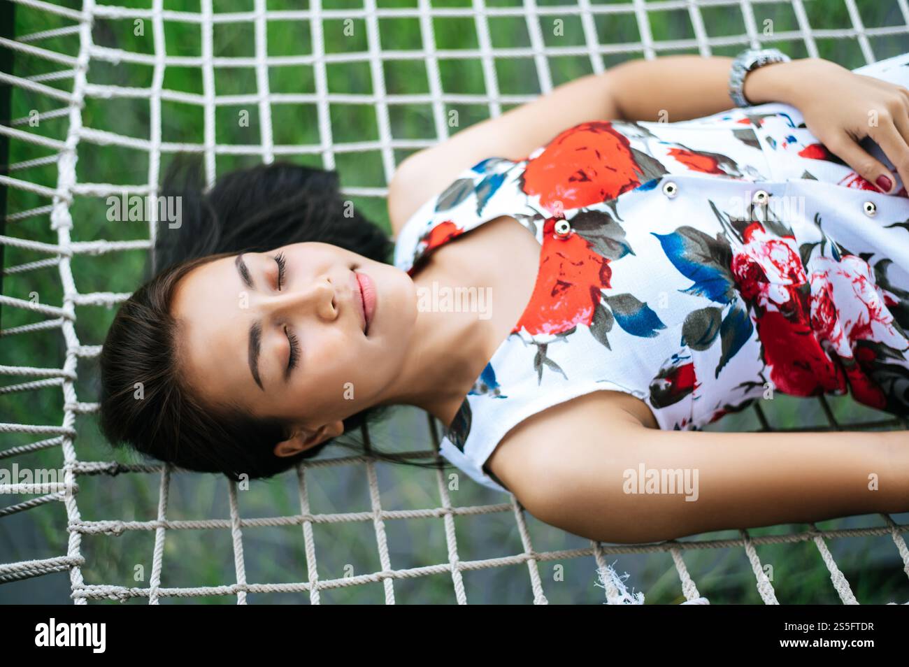 woman lying on a net rope Stock Photo - Alamy