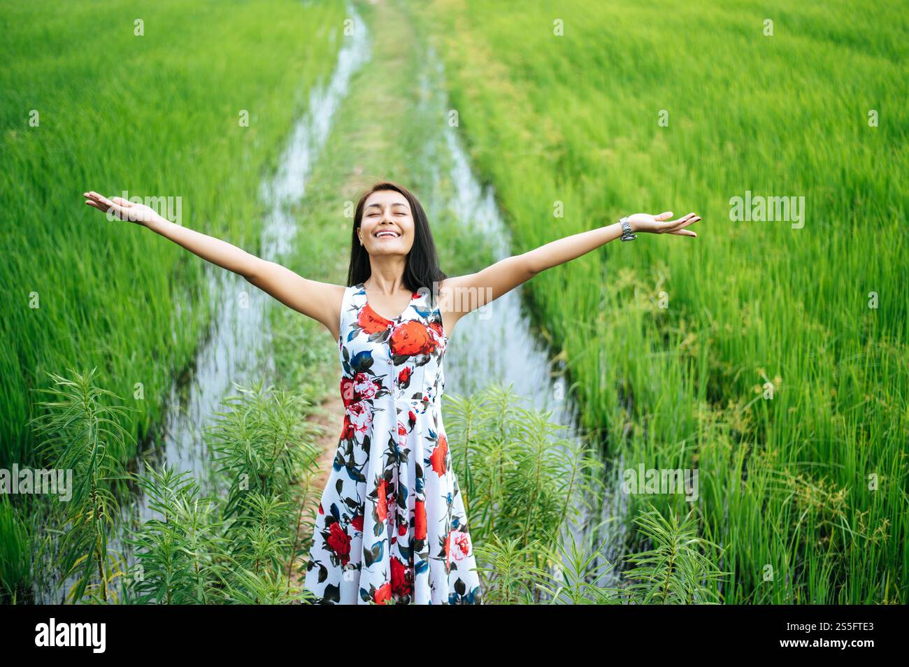 Beautiful women walk happily on the meadow Stock Photo - Alamy