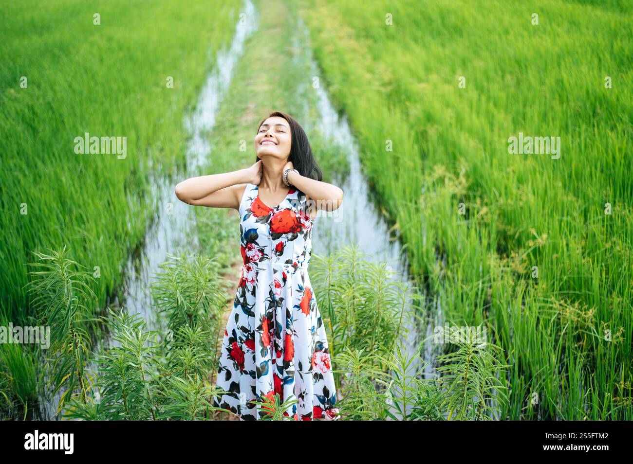 Beautiful women walk happily on the meadow Stock Photo - Alamy