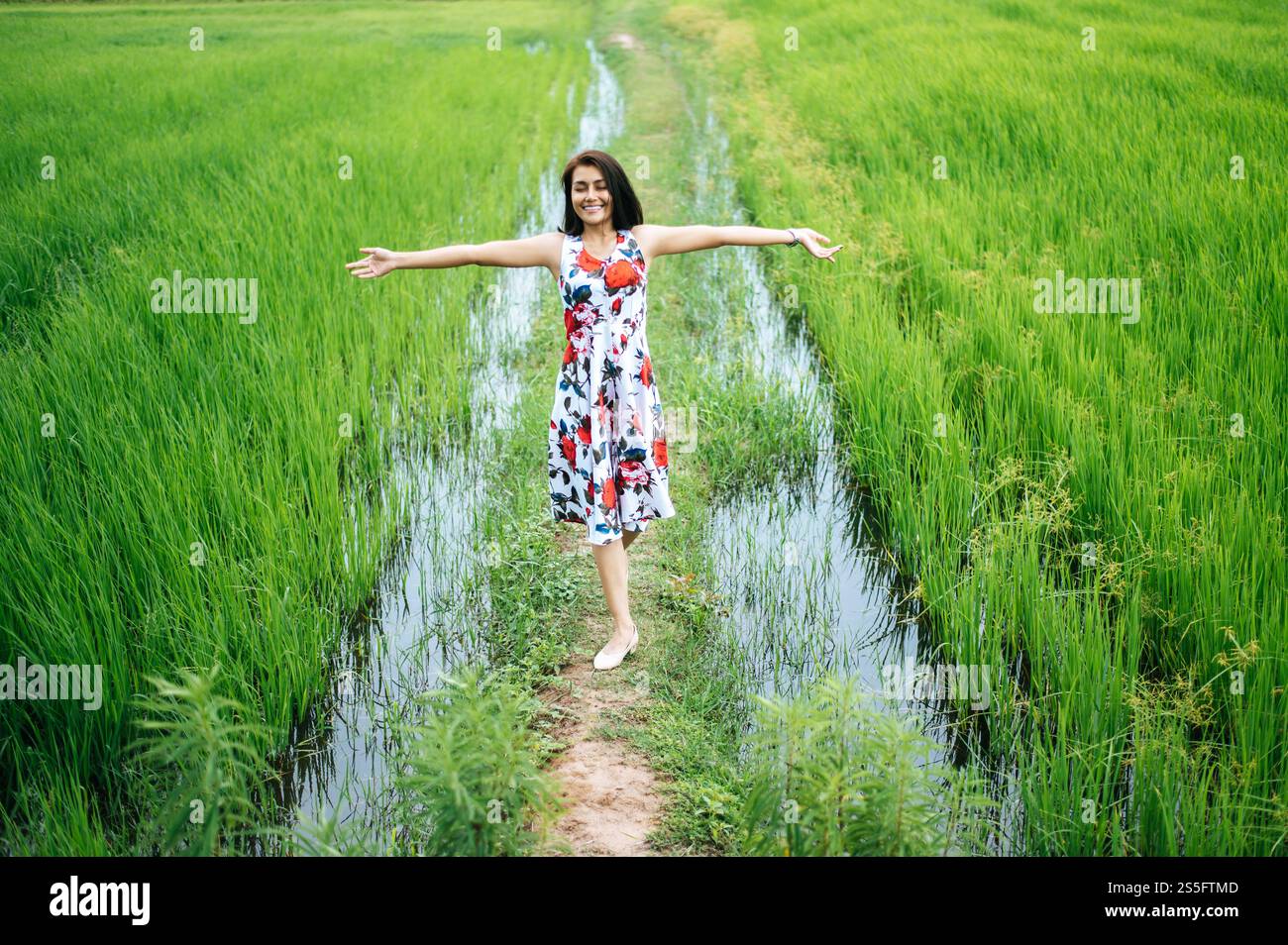 Beautiful women walk happily on the meadow Stock Photo - Alamy