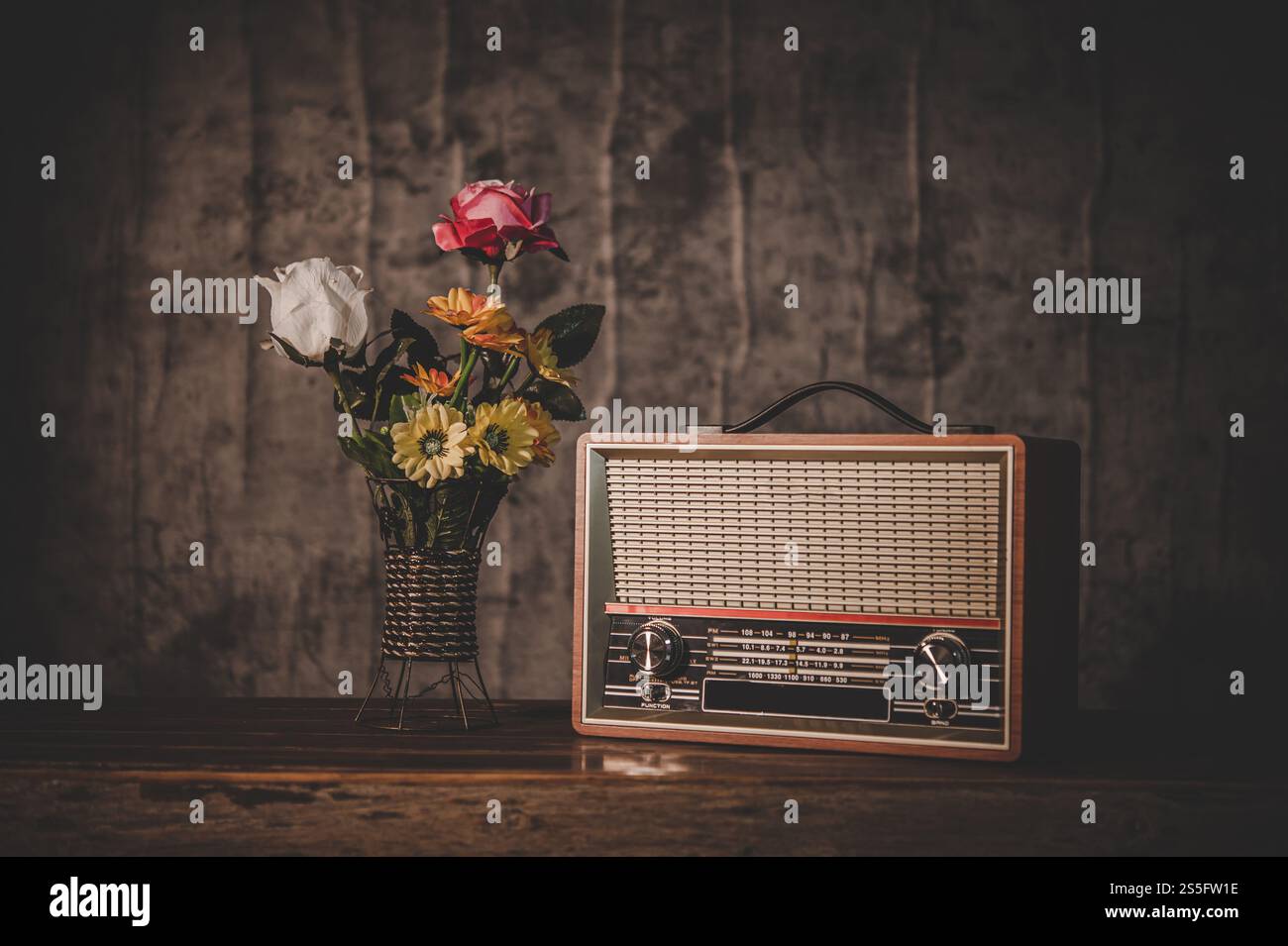 Still life with a retro radio receiver and flower vases Stock Photo - Alamy