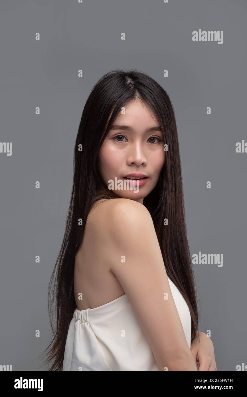 The women wear white strapless tops and face to the right Stock Photo ...