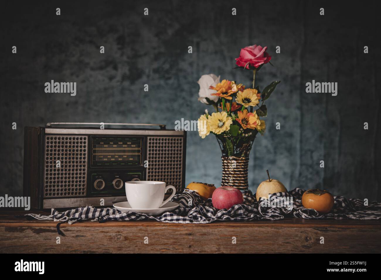 Still life with vases, flowers, fruit, coffee cups and a retro radio ...