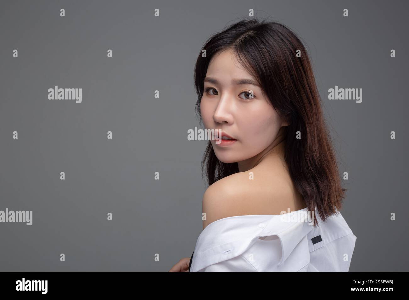 The woman wears a white shirt and faces his left hand Stock Photo - Alamy