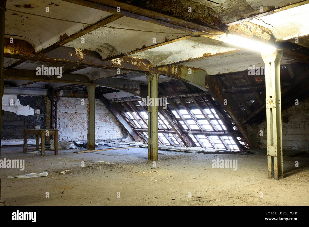 Abandoned industrial building interior with sunlight streaming through ...