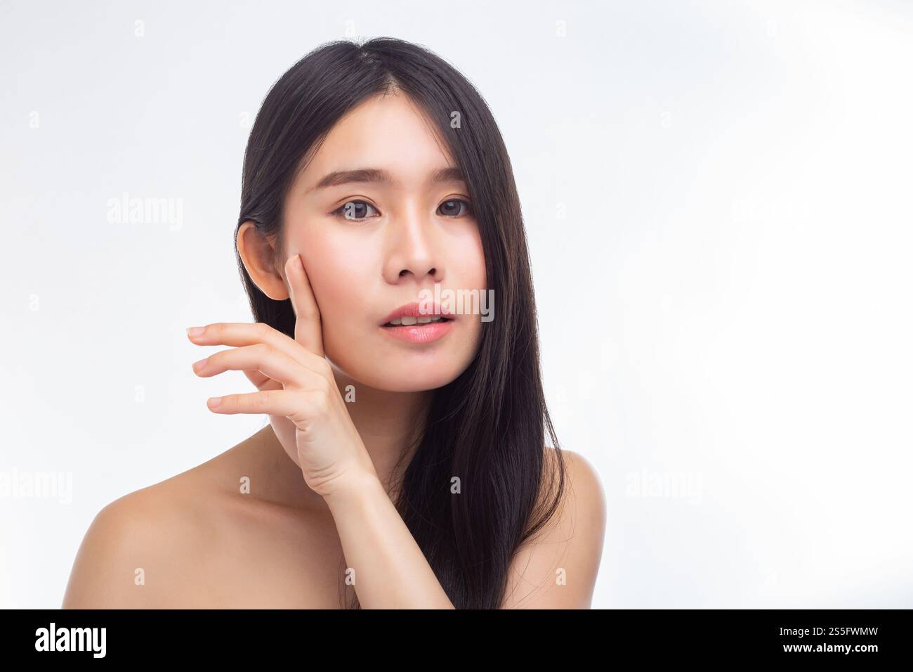 The woman wore a white strapless dress and hands touch her face Stock ...