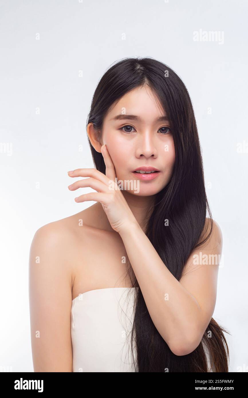 The woman wore a white strapless dress and hands touch her face Stock ...