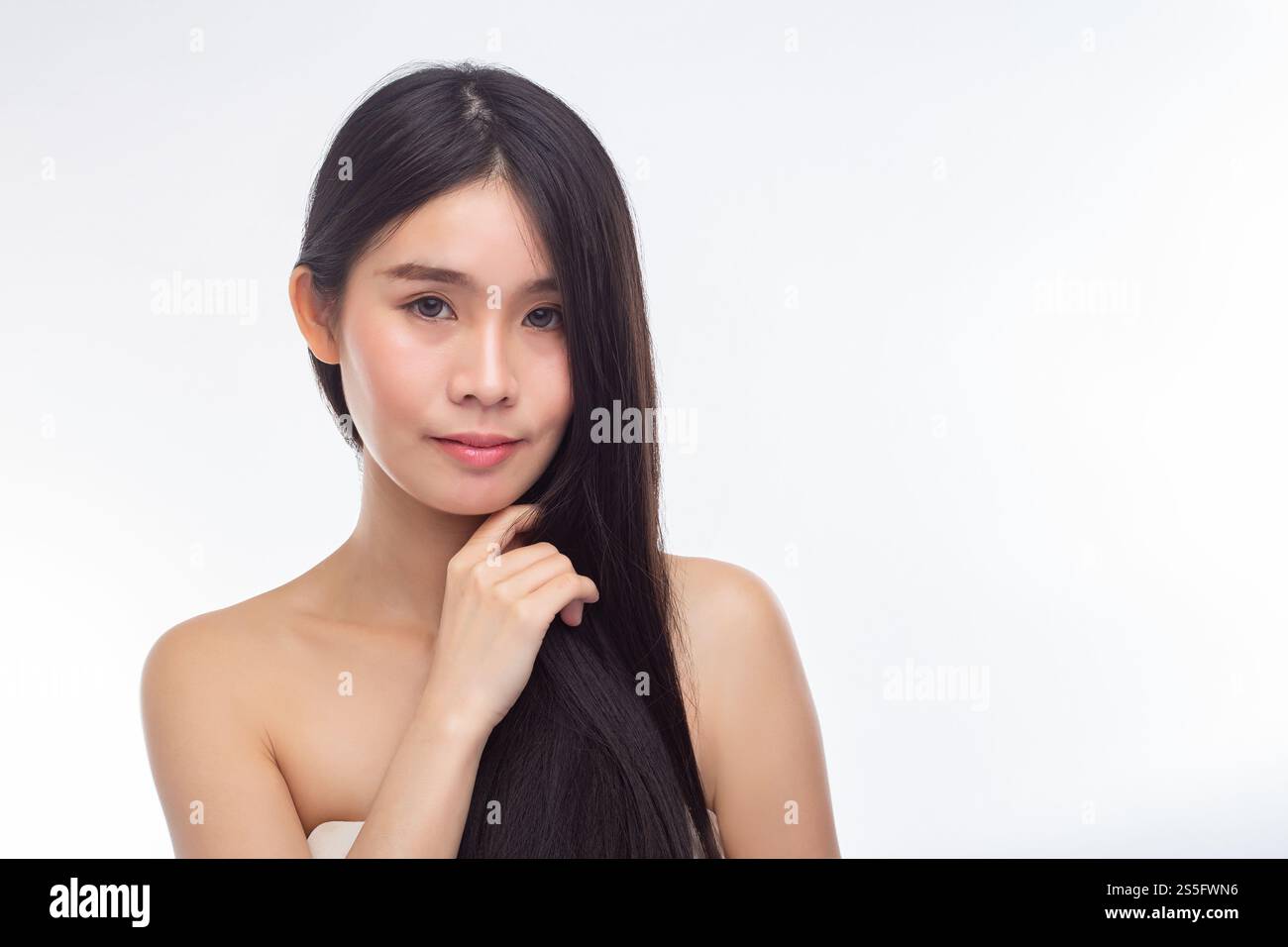 Woman wearing a white strapless dress and hands touching the chin Stock ...