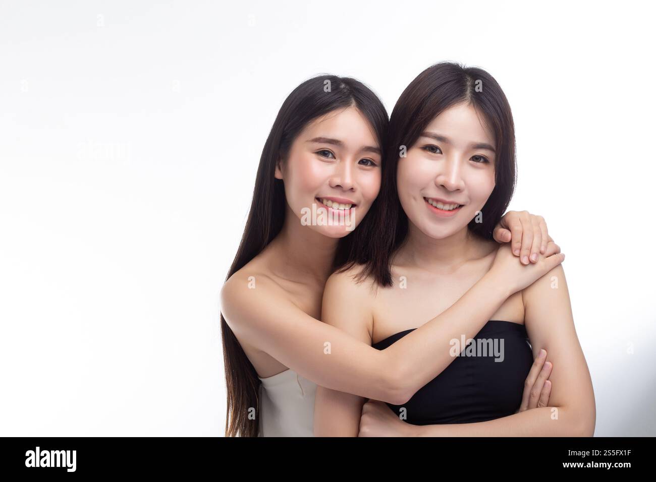 Two young women hug each other happily Stock Photo - Alamy