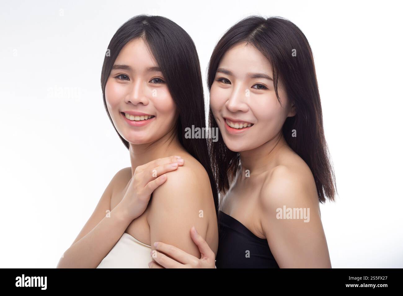 Two young women happily stood together from behind Stock Photo - Alamy