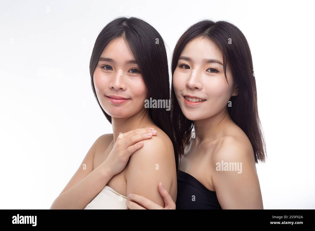 Two young women happily stood together from behind Stock Photo - Alamy