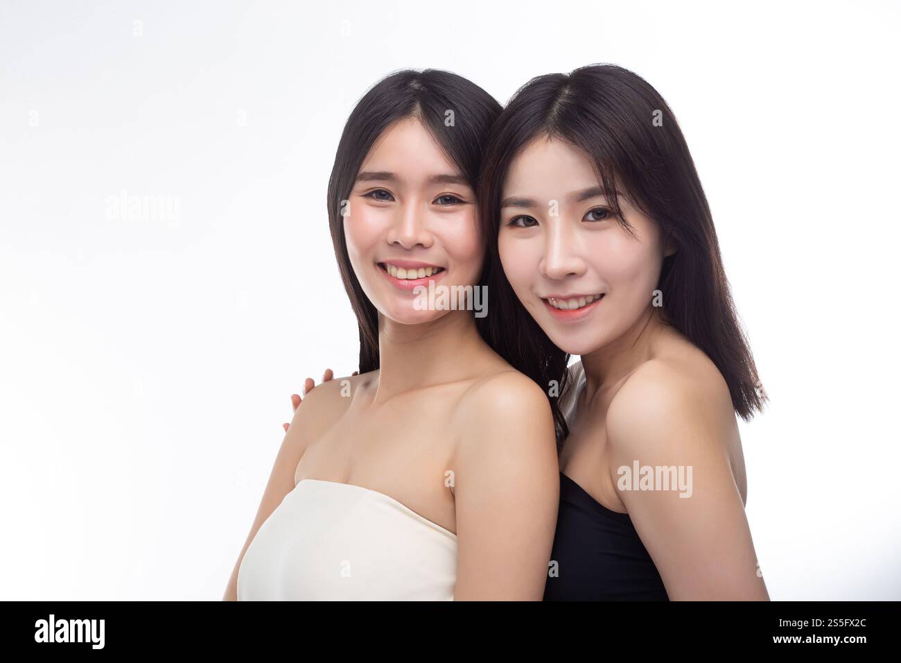 Two young women happily stood together from behind Stock Photo - Alamy