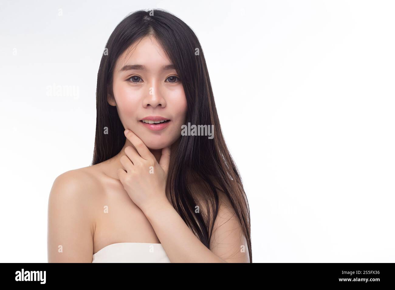 Woman wearing a white strapless dress and hands touching the chin Stock ...