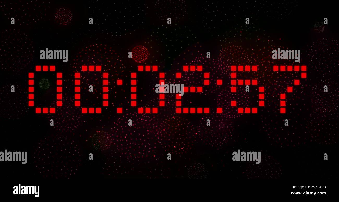 Image of digital clock counting down to midnight with fireworks on ...