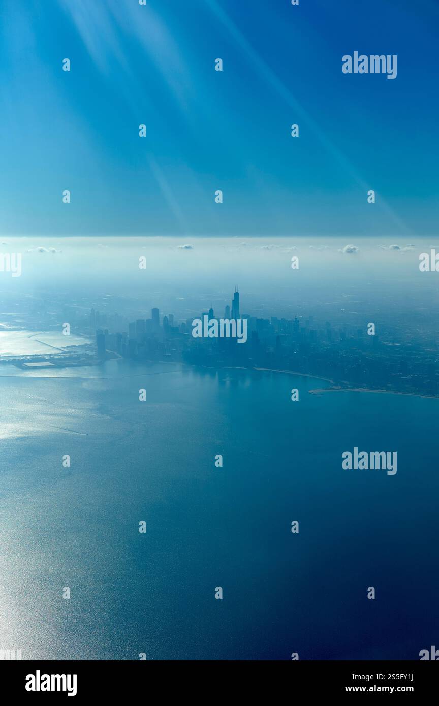 Aerial view city skyline blue sky sunlight beams water foreground hi ...