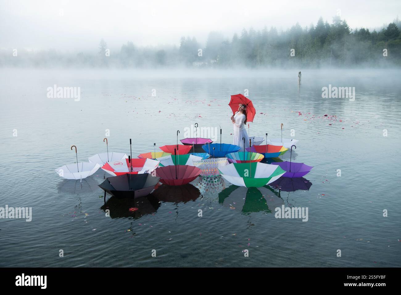 A serene lake scene with various colorful umbrellas floating on the ...