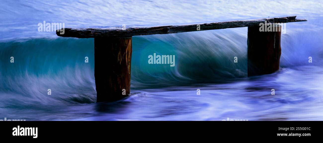 Wooden pier remnants stand swirling motion blue ocean waves hi-res ...