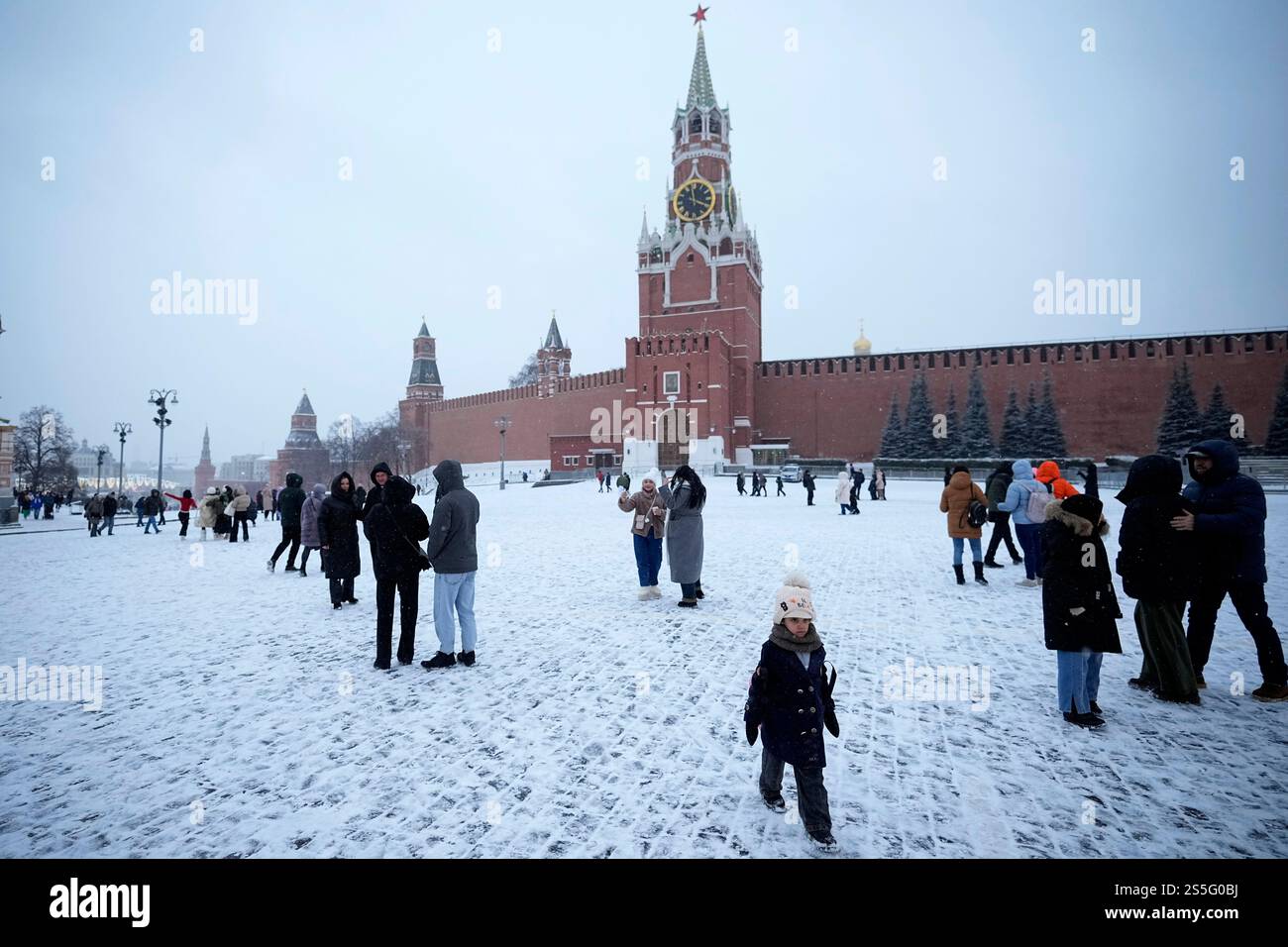People walk at the Red Square during a snowfall in Moscow, Russia ...