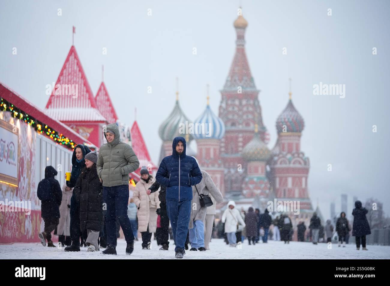 People walk at the Red Square during a snowfall in Moscow, Russia ...