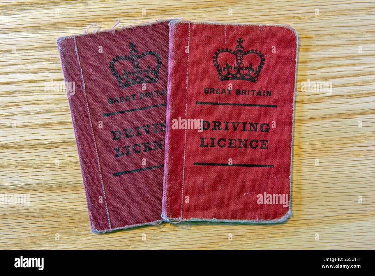 2 old red, fabric covered UK driving licences, dated 1969 and 1975 on ...
