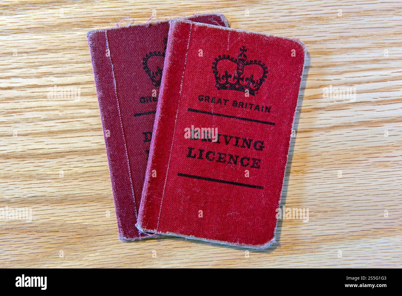 2 old red, fabric covered UK driving licences, dated 1969 and 1975 on ...