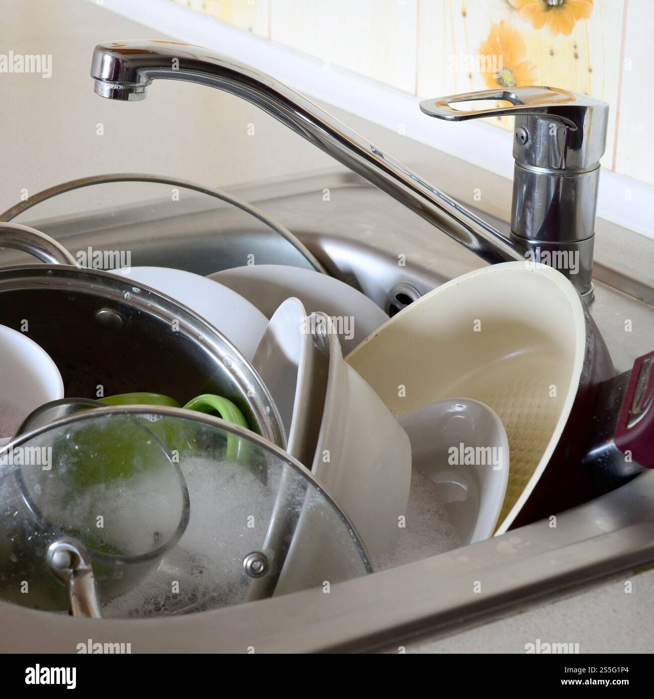Dirty dishes and unwashed kitchen appliances filled the kitchen sink ...