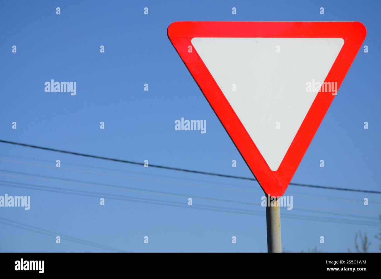 Traffic sign in the form of a white triangle. Give way Stock Photo - Alamy