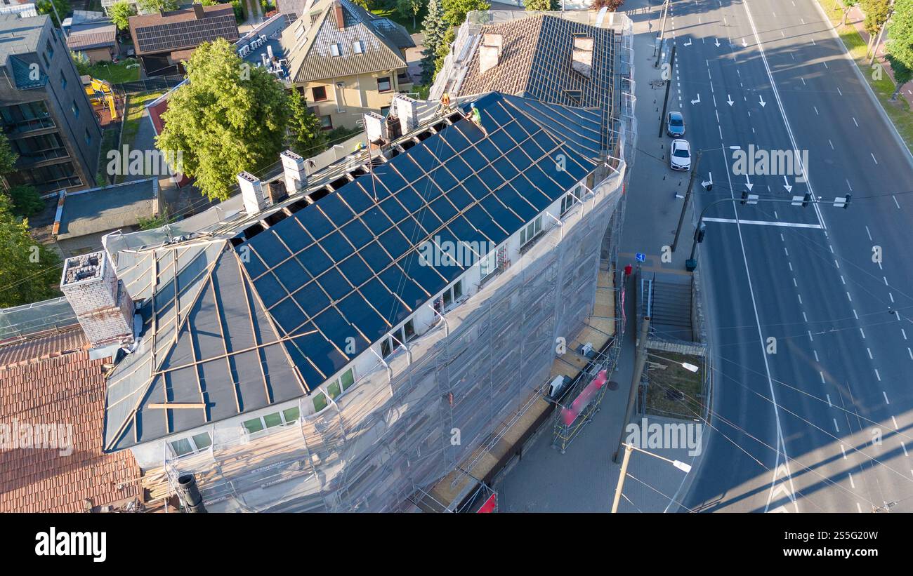 Aerial view of a building under renovation with scaffolding and a ...